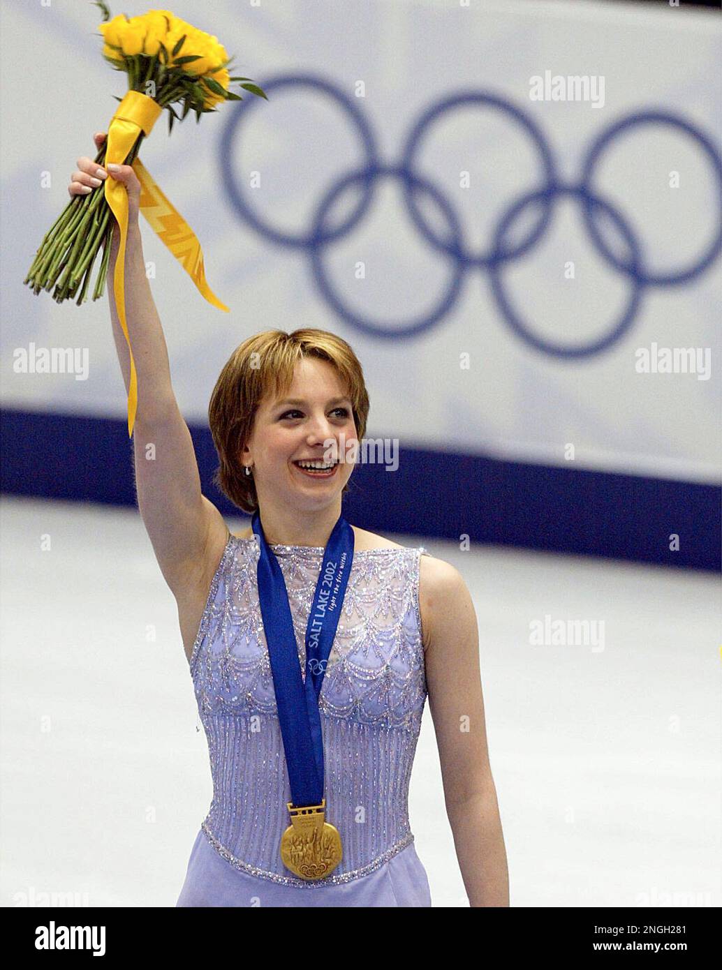Sarah Hughes of the United States waves to the crowd with her gold ...