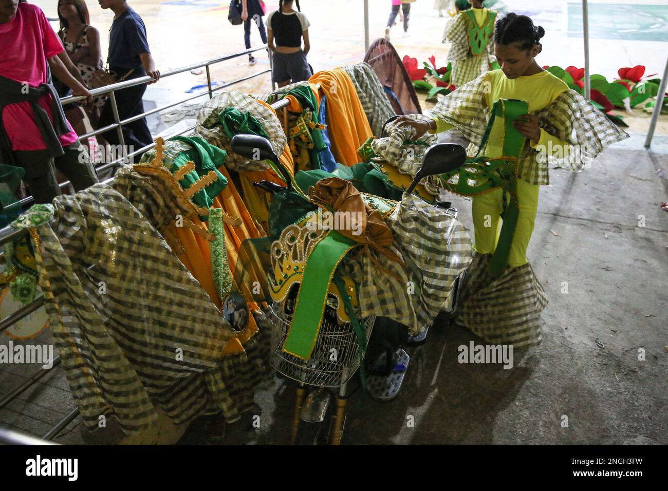 A performer puts on their costume hours before the 2023 Sikhayan festival. Locals from their ...