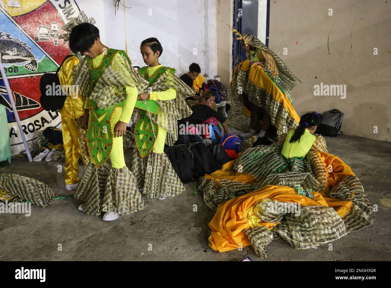 Performers put on their costume hours before the 2023 Sikhayan festival. Locals from their town ...