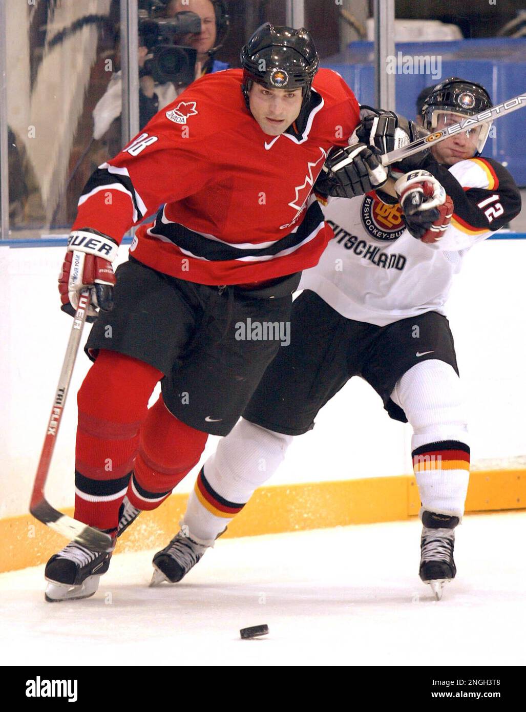 Canada's Eric Lindros (88) battles with Germany's Mirko Ludemann (12) during second period at ...