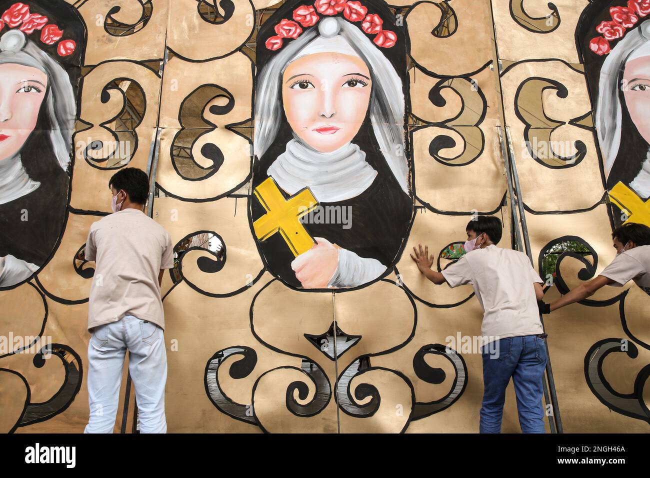 Propsmen hold their group's background with an image of St. Rose of ...