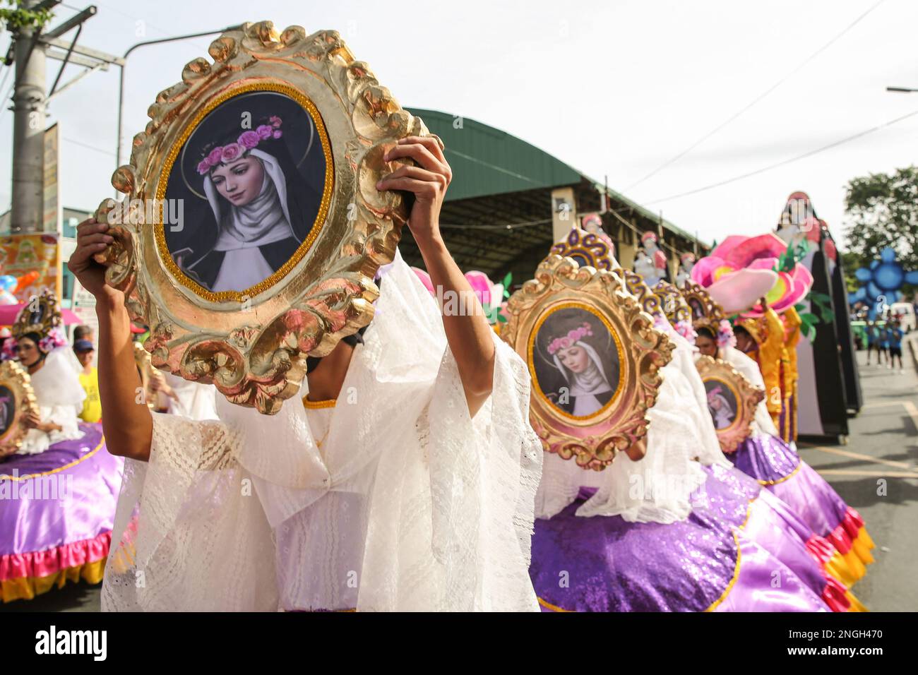 Performers dance while holding an image of St. Rose of Lima during the ...