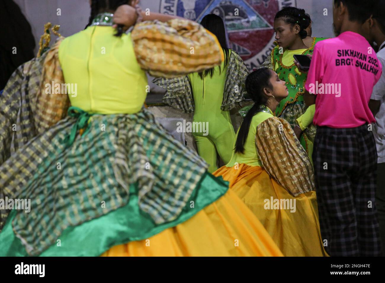 A performer gets her makeup done hours before the 2023 Sikhayan festival. Locals from their town ...