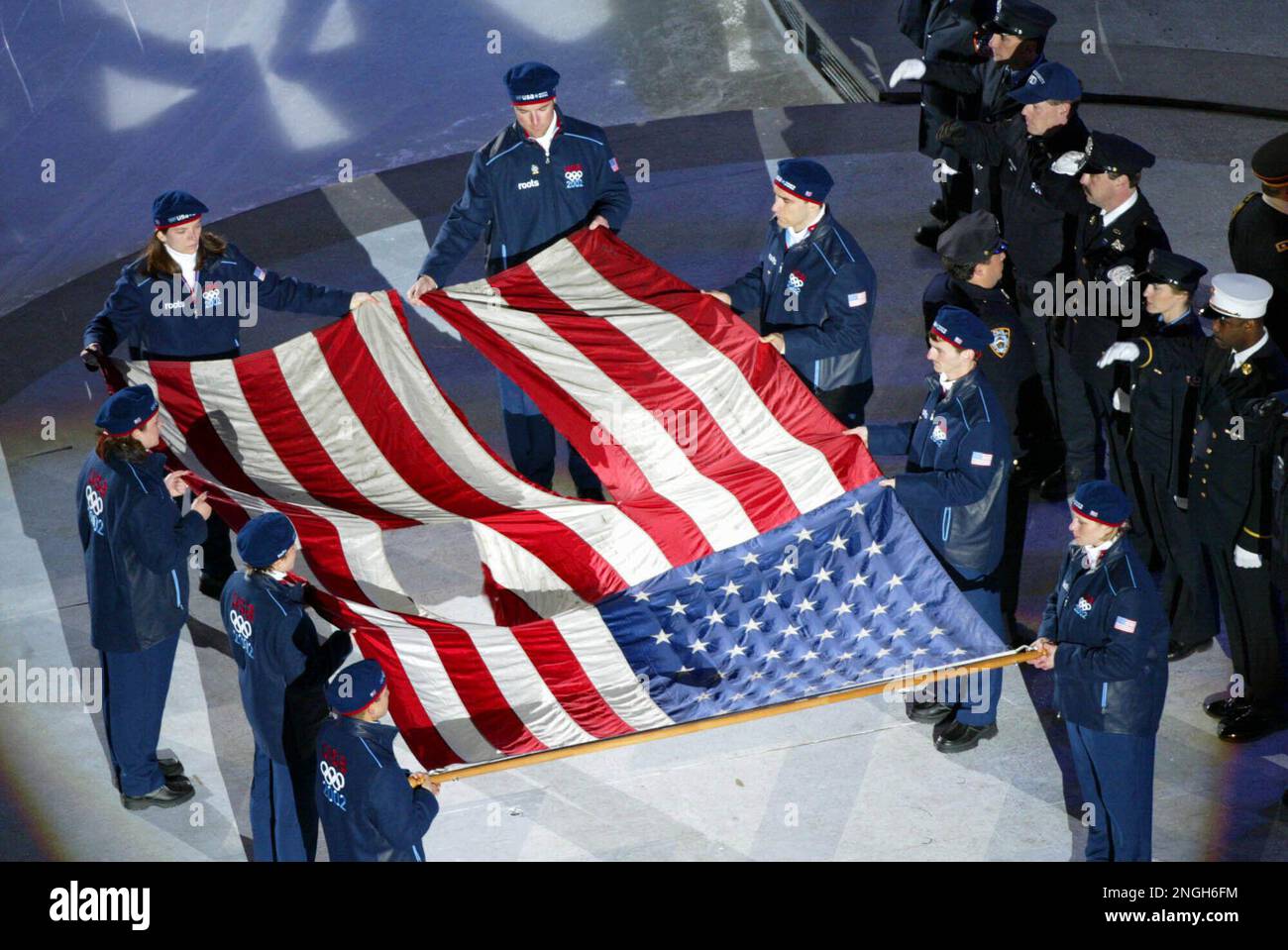 Olympians carry the tattered American flag from the World Trade Center ...