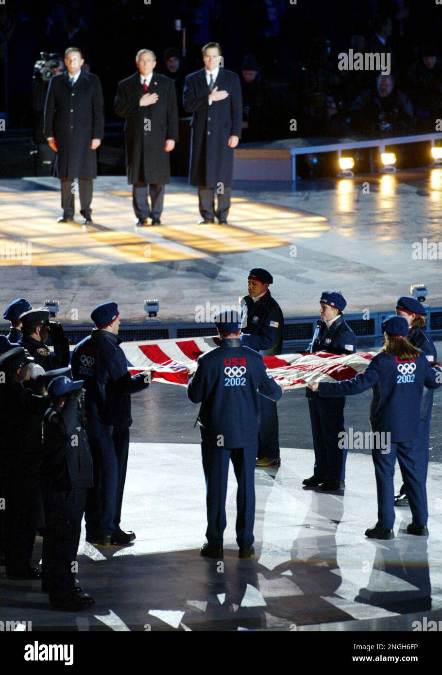 Olympians carry the tattered American flag from the World Trade Center ...