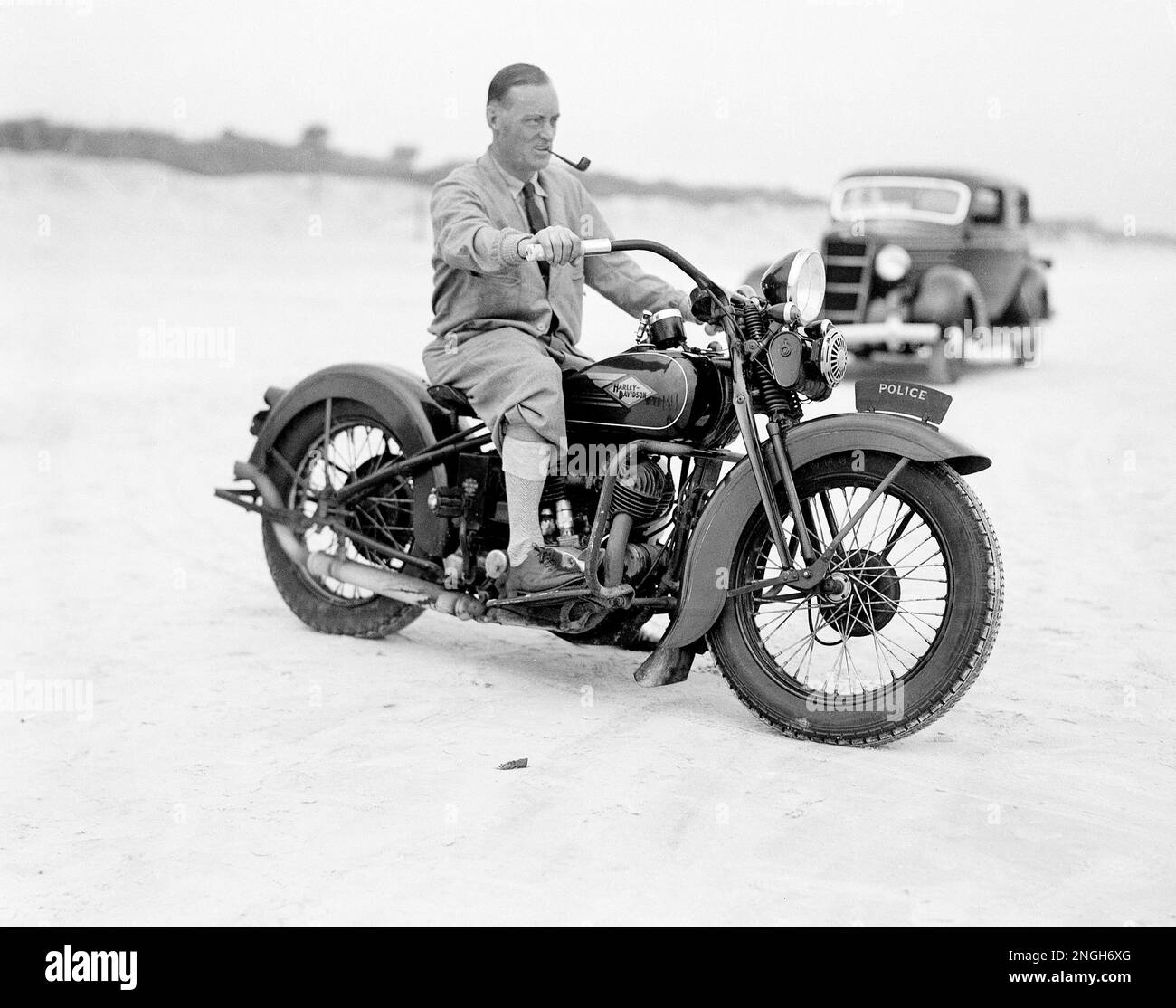 British race car driver Sir Malcolm Campbell rides a Harley Davidson ...