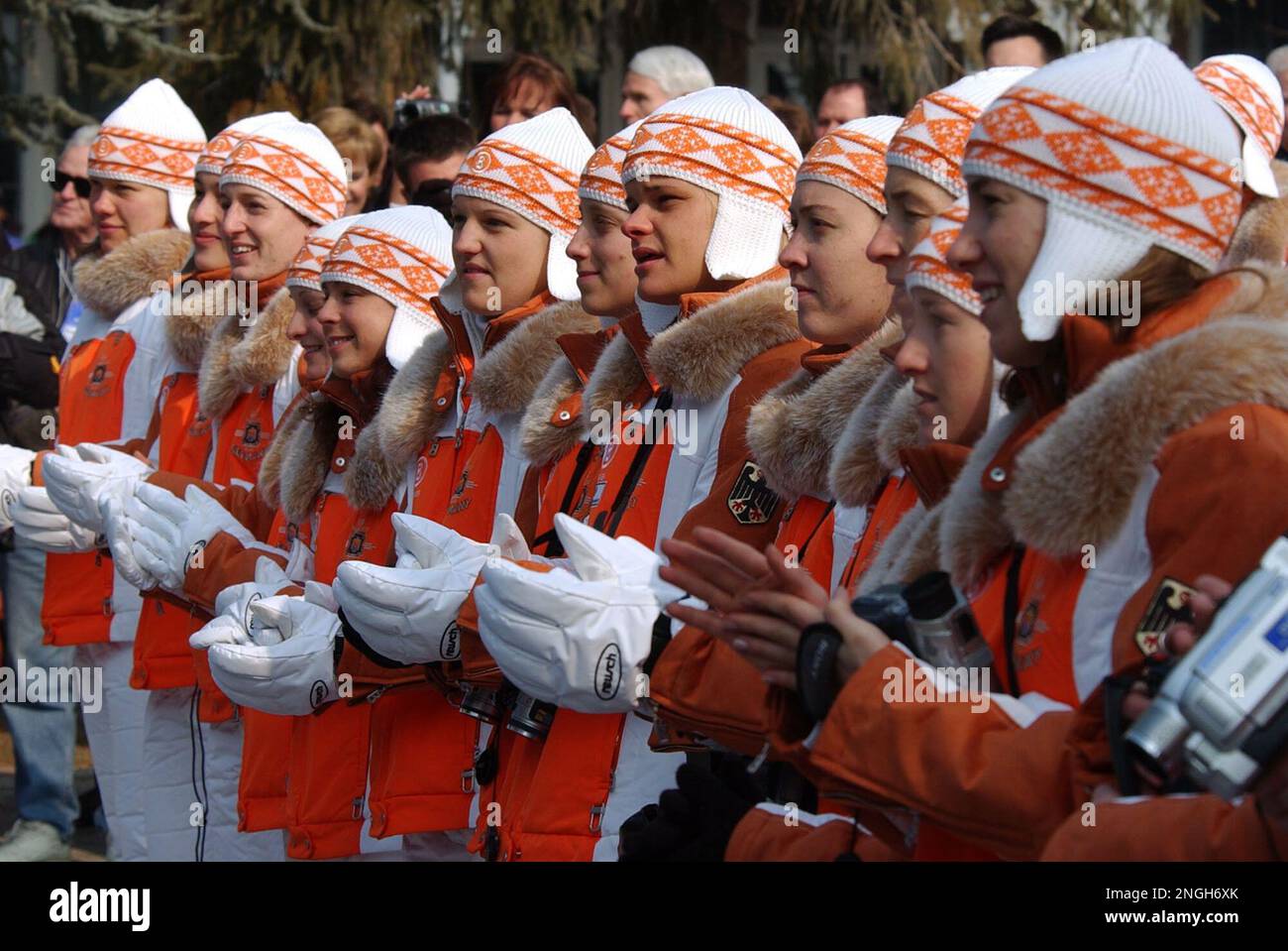 Members of the German winter olympic team listen to a group of local ...