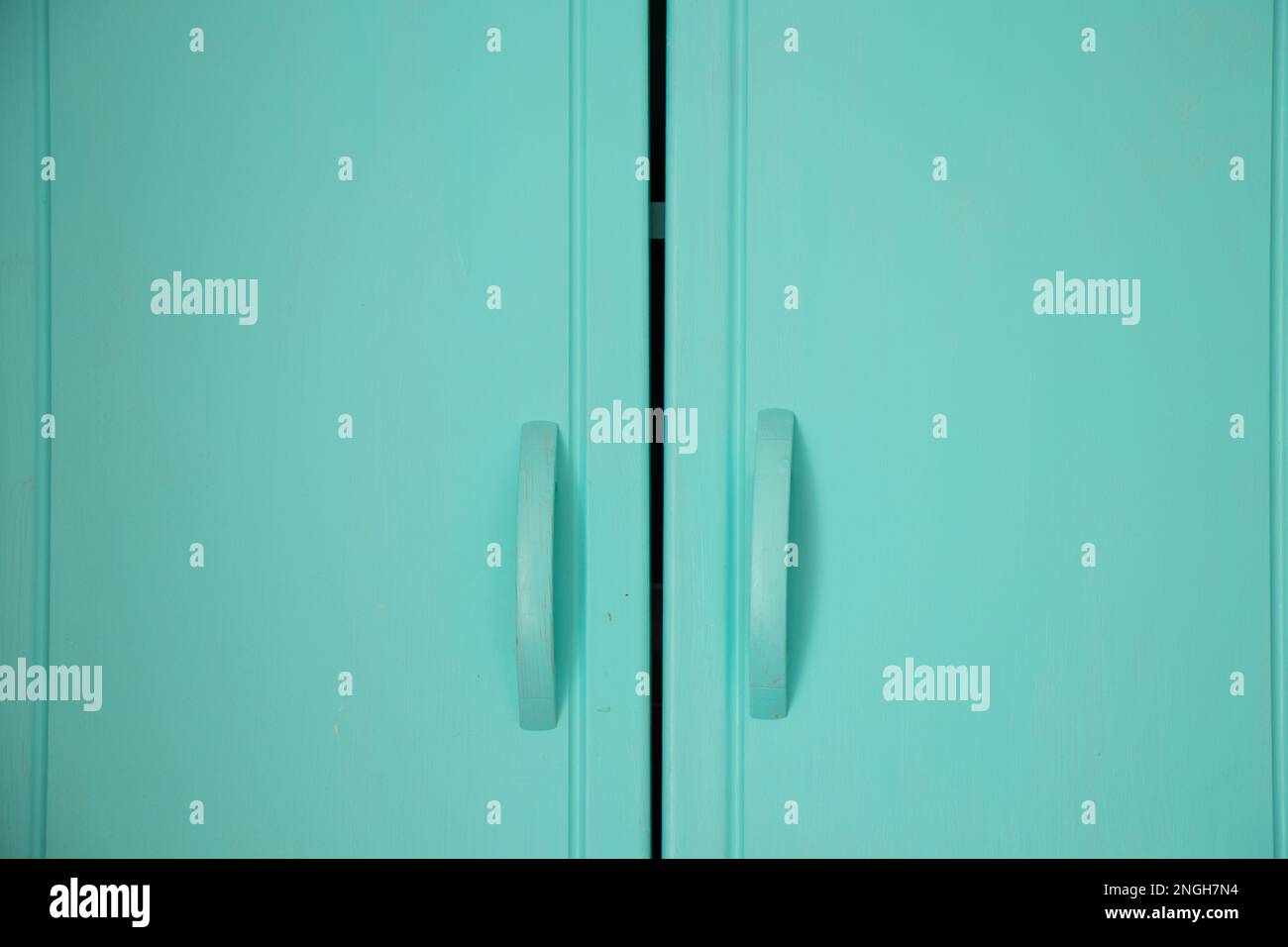 kitchen cabinet as background painted in turquoise color close-up ...