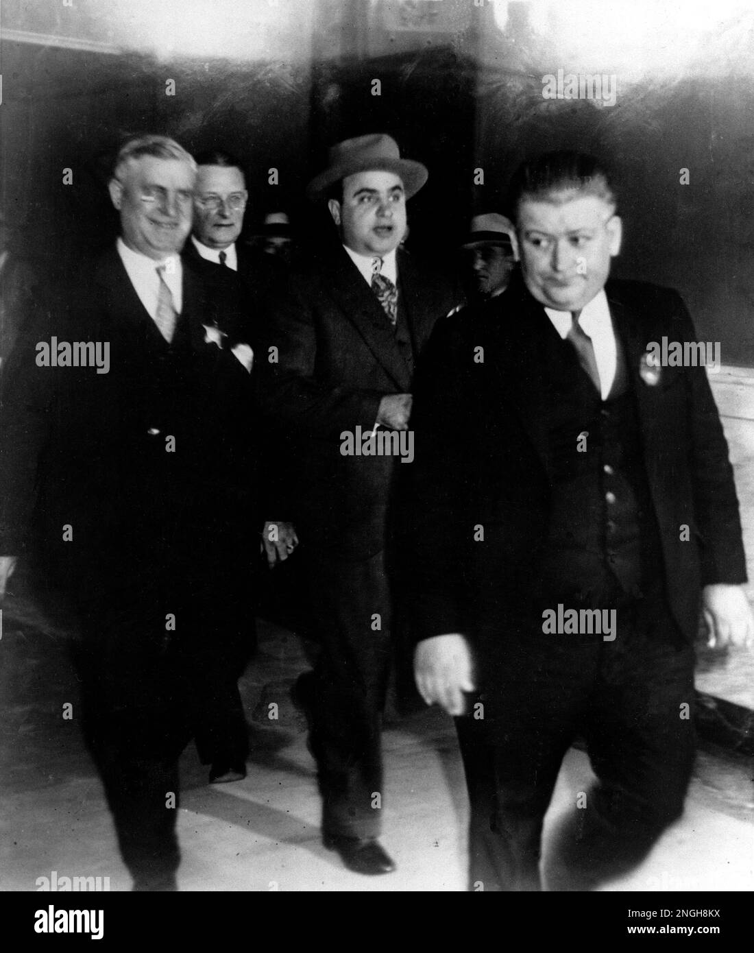 Al Capone, center, in custody of United States marshals, leaves the ...