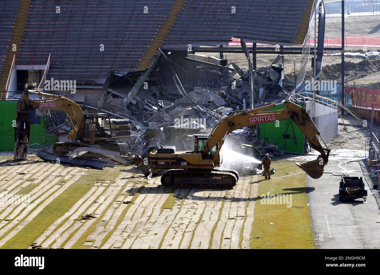 Demolition workers begin tearing down the south stands at Mile High ...