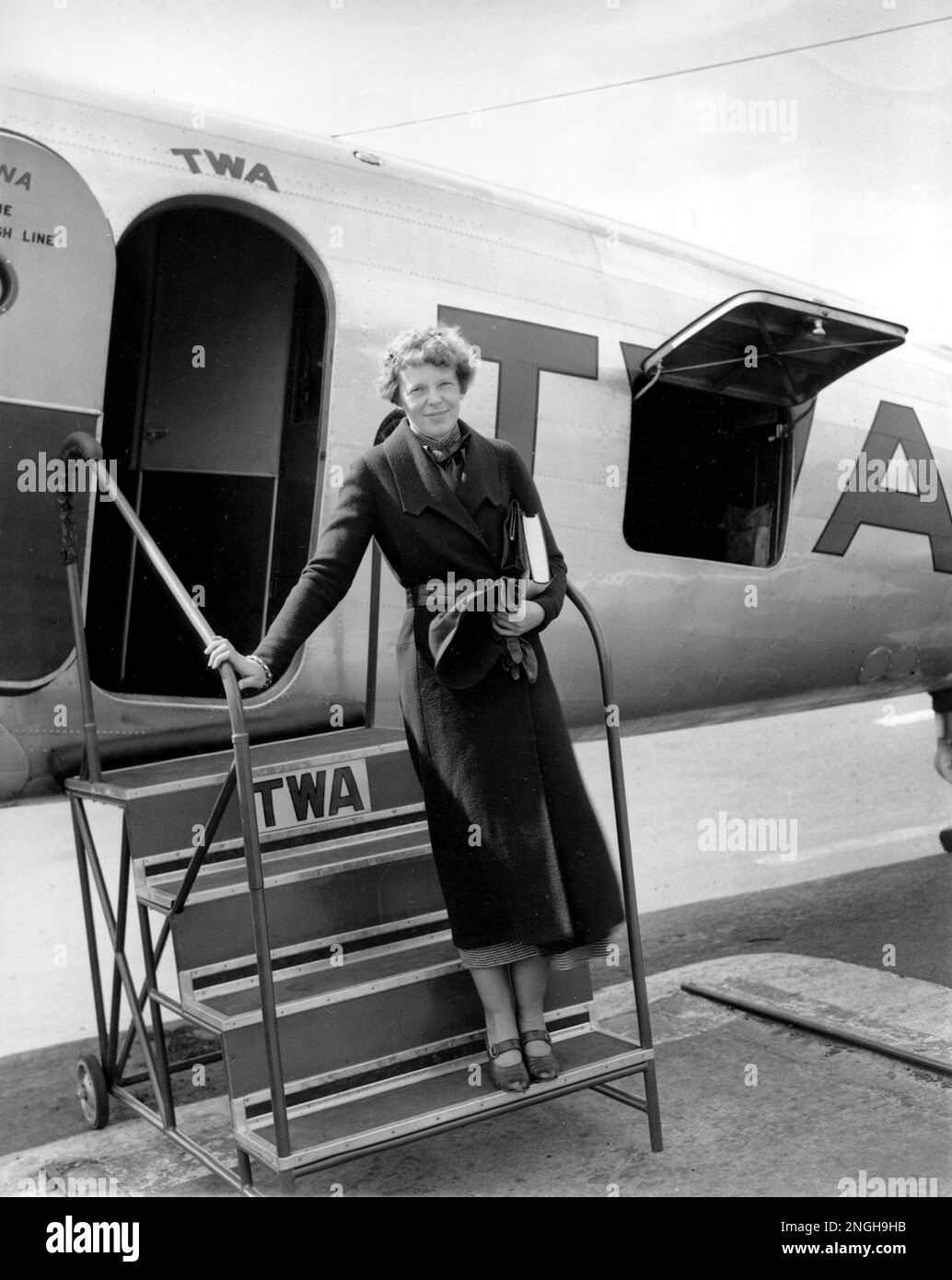 American aviatrix Amelia Earhart poses before boarding a TWA airplane ...