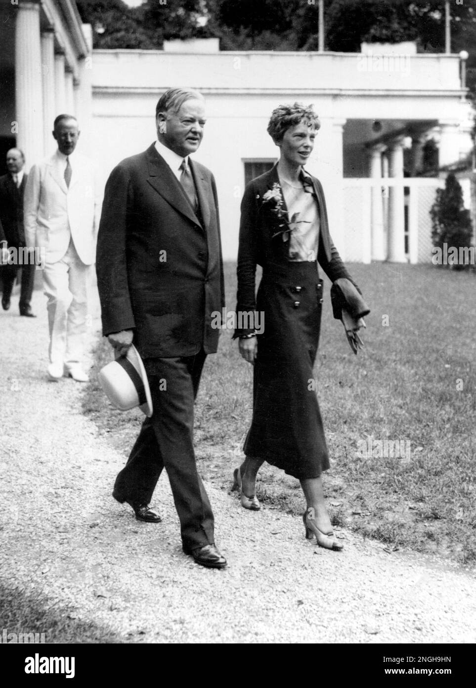 American aviatrix Amelia Earhart and U.S. President Herbert Hoover walk ...