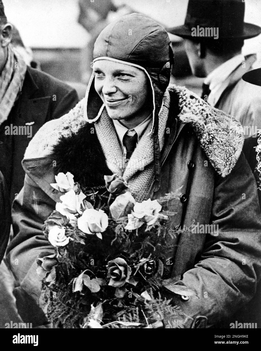 American aviatrix Amelia Earhart poses with flowers as she arrives in ...