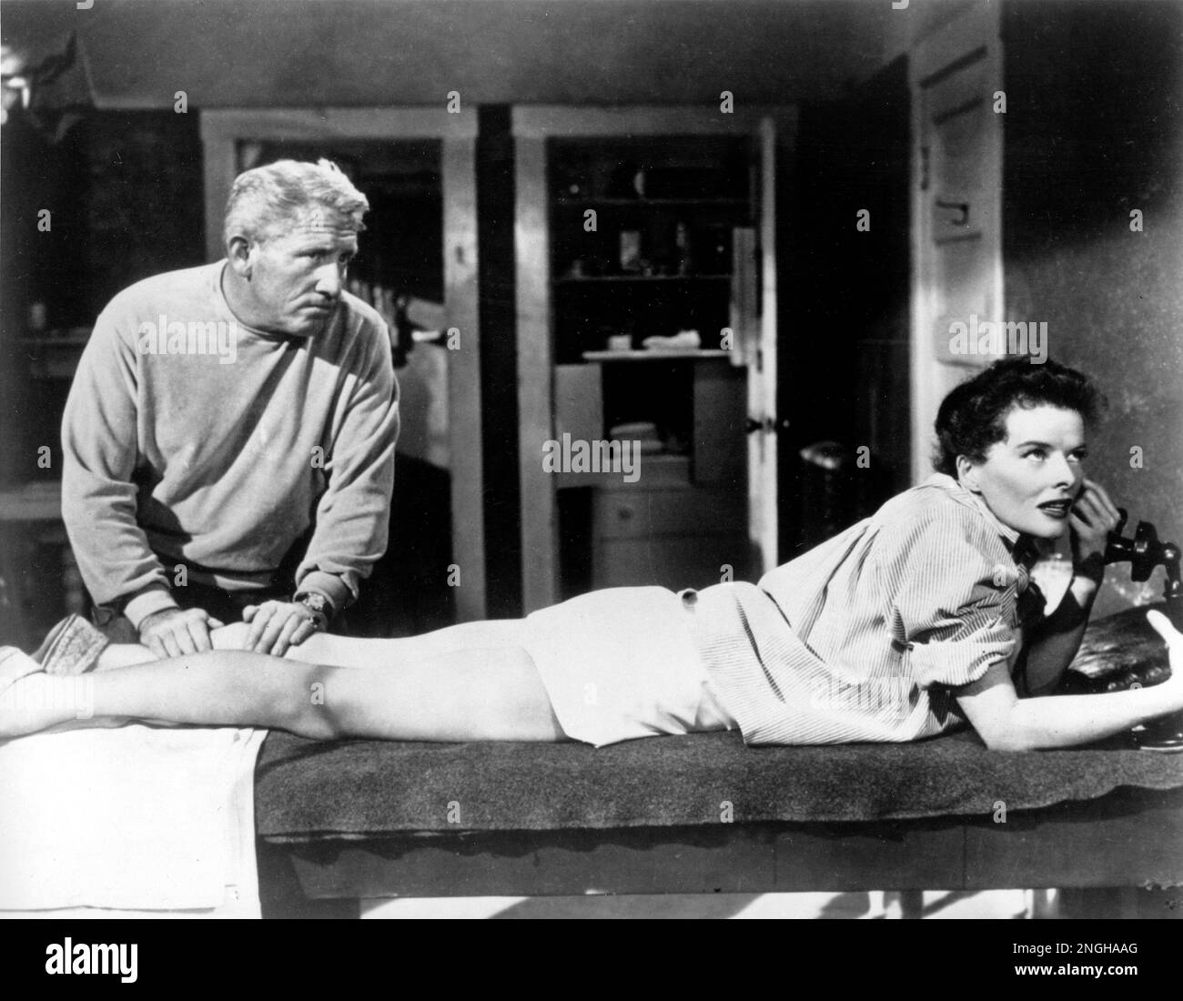 Katharine Hepburn and Spencer Tracy are shown in character in a scene ...