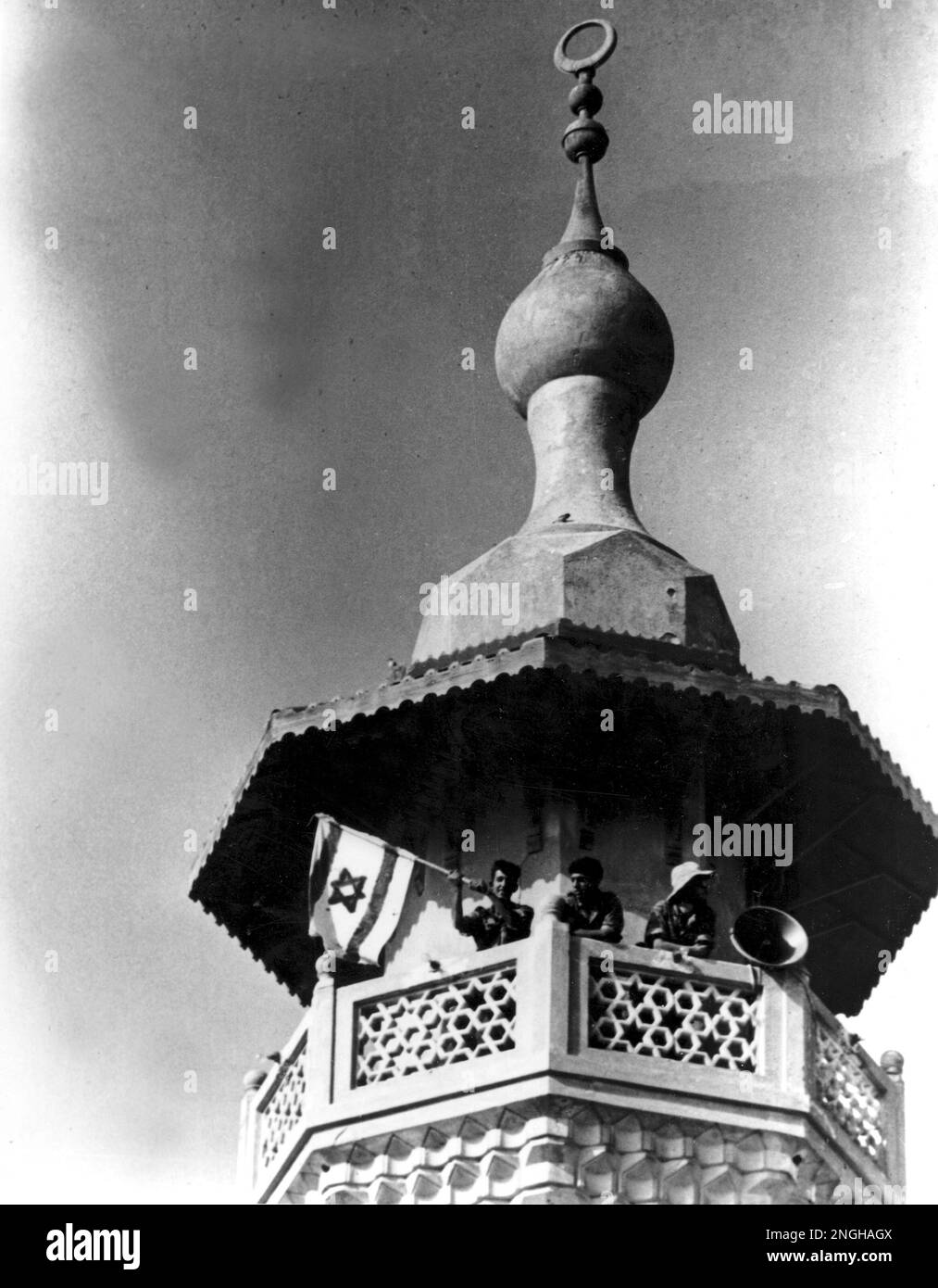 Israeli soldiers wave their flag from the minaret of the mosque of El ...