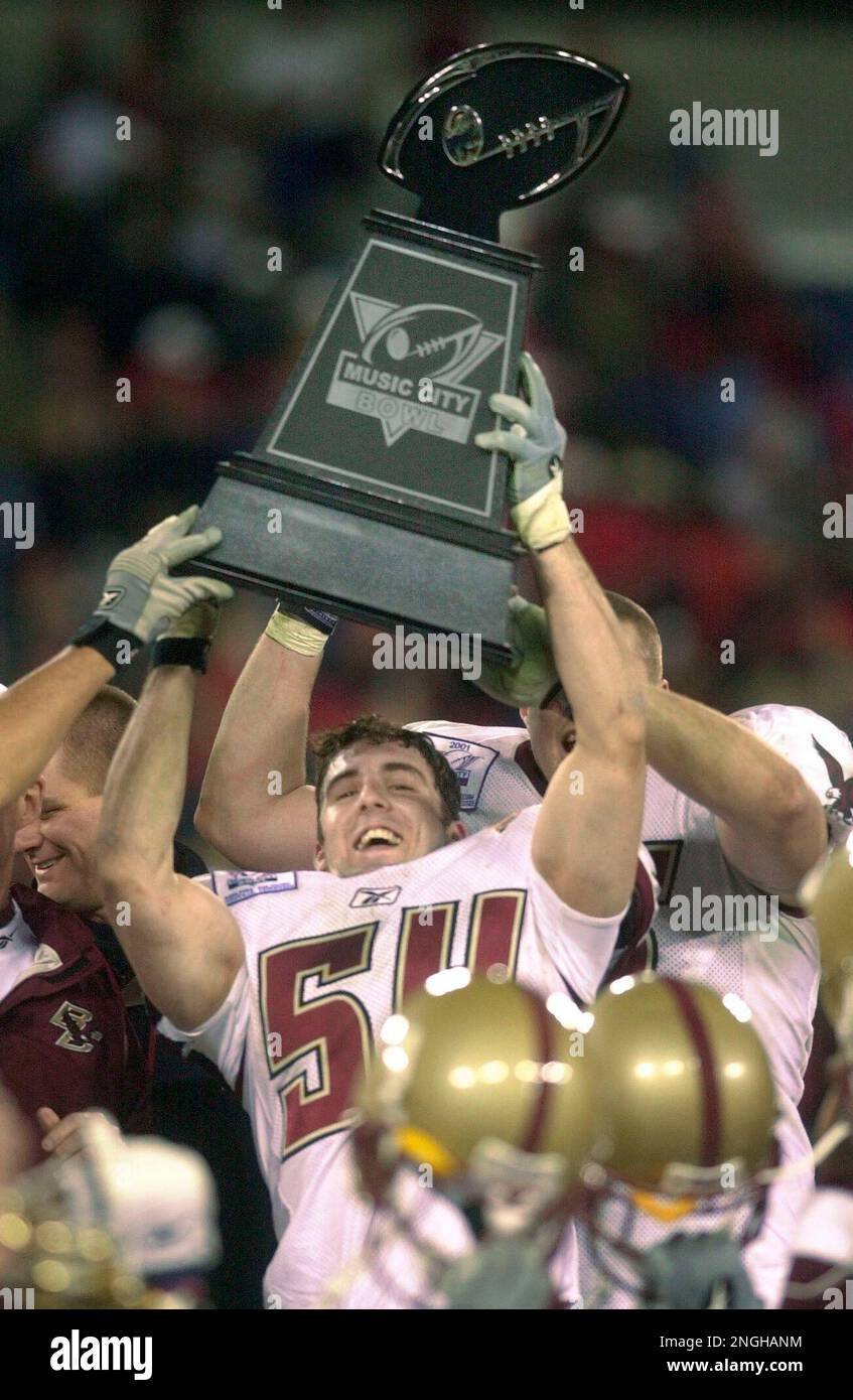 Boston College linebacker Scott Bradley (54) raises the Music City Bowl ...