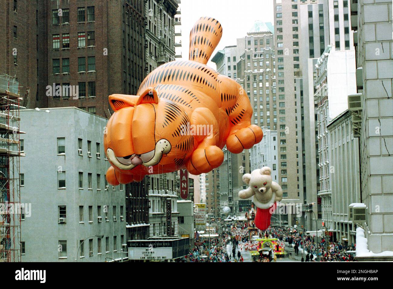 Garfield the Cat, with Snuggle the Bear behind, floats down Broadway in ...