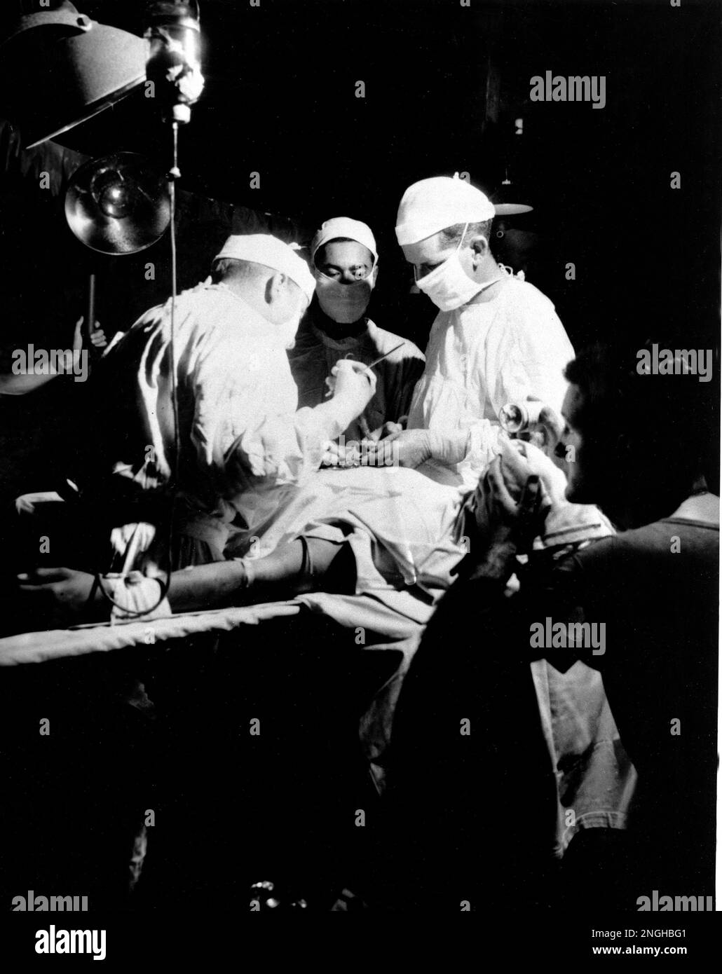 While a U.S. corpsman administers ether, Navy doctors operate to remove ...