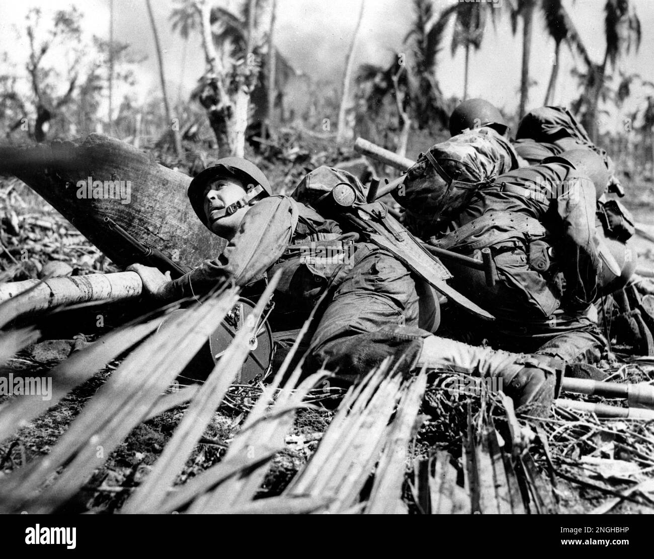 American soldiers take cover from fire of a Japanese machine gun in the ...