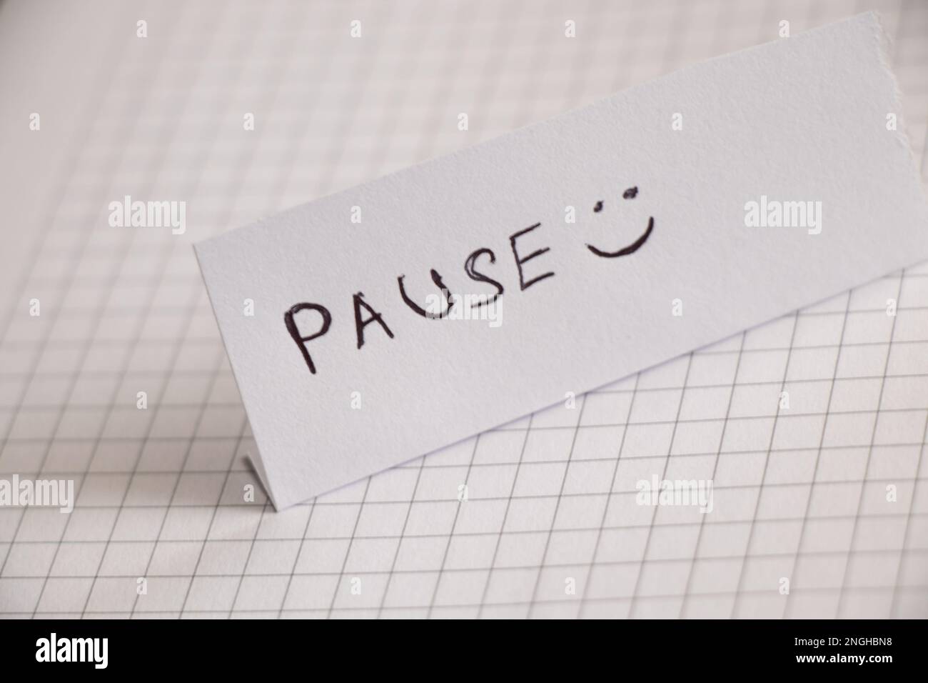 Pause and smiley handwritten on a piece of paper and left Stock Photo ...