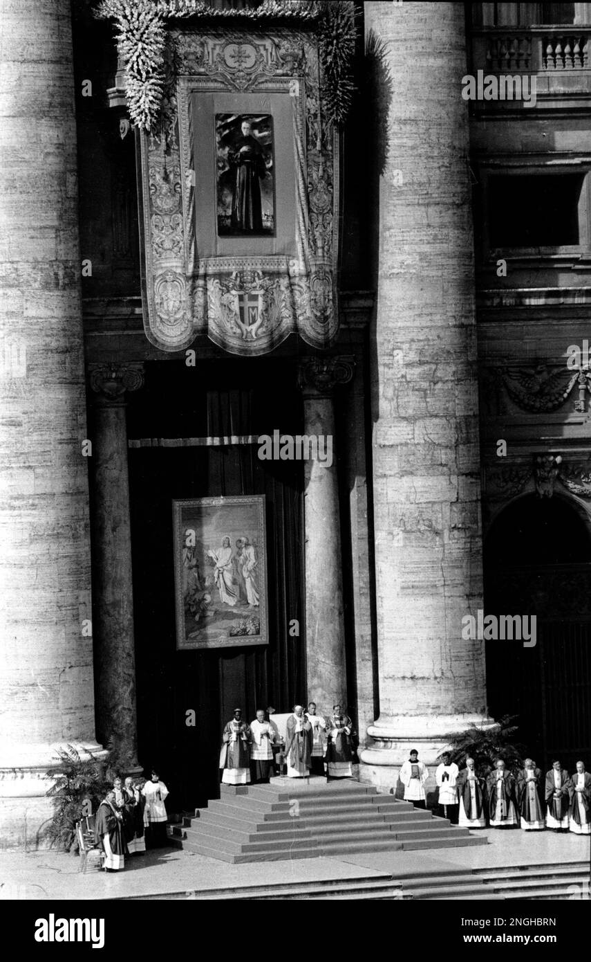 Pope John Paul II stands with other clergy amidst the towering columns ...