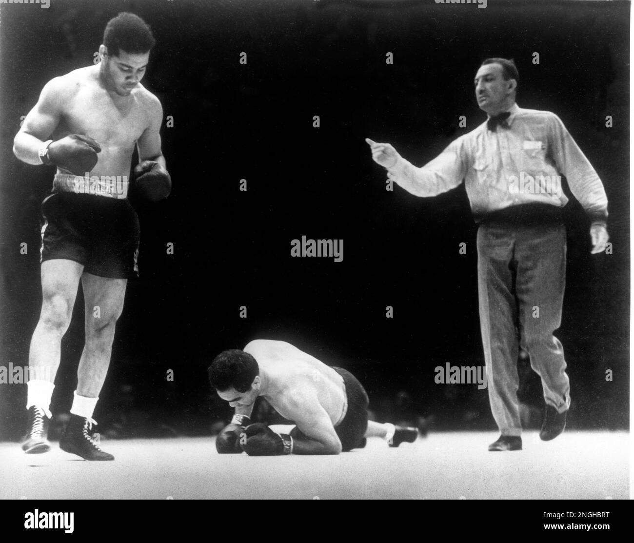 World heavyweight boxing champion Joe Louis stands over challenger Max ...