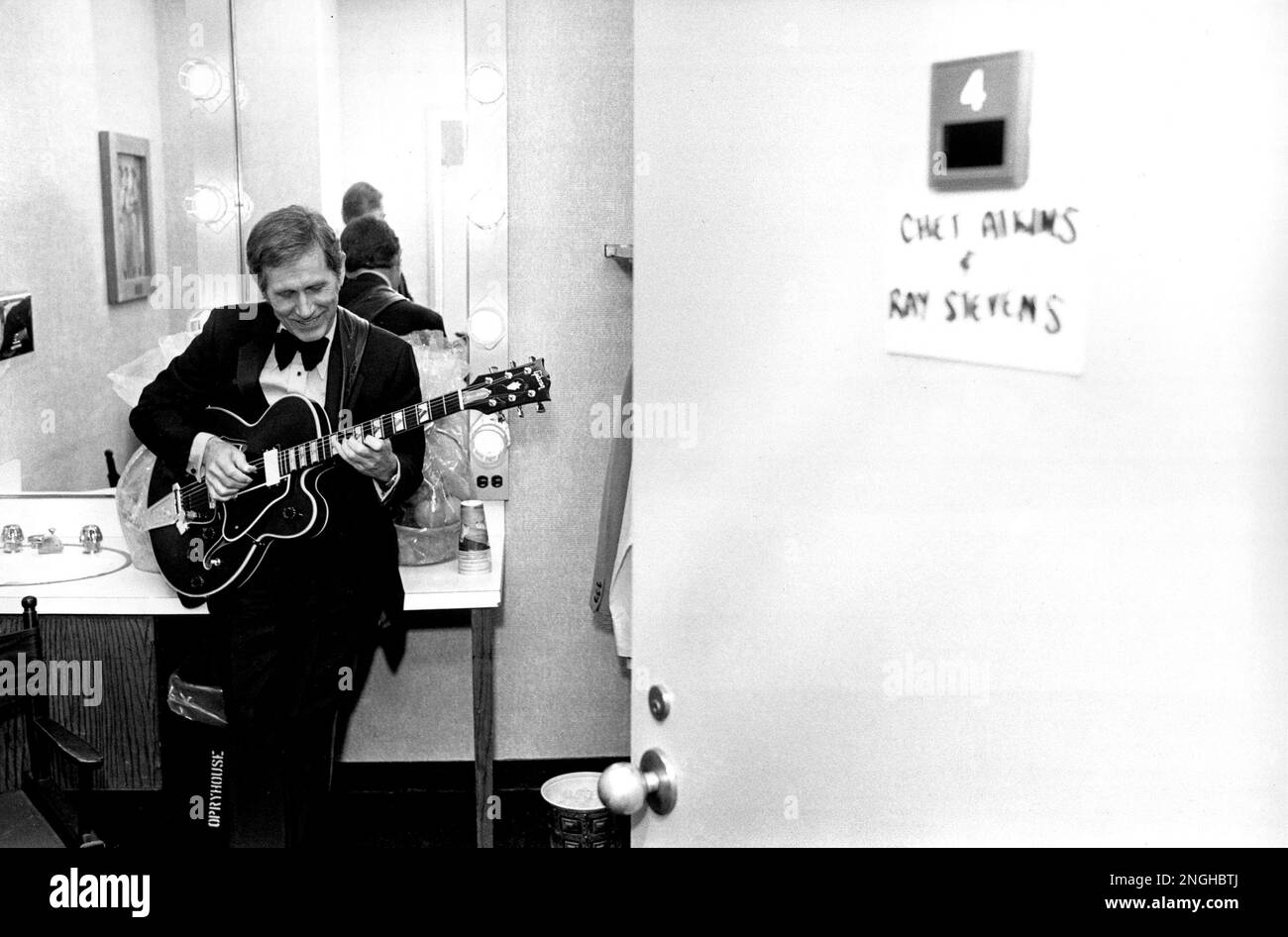 Guitarist Chet Atkins plays the guitar in his dressing room at the ...
