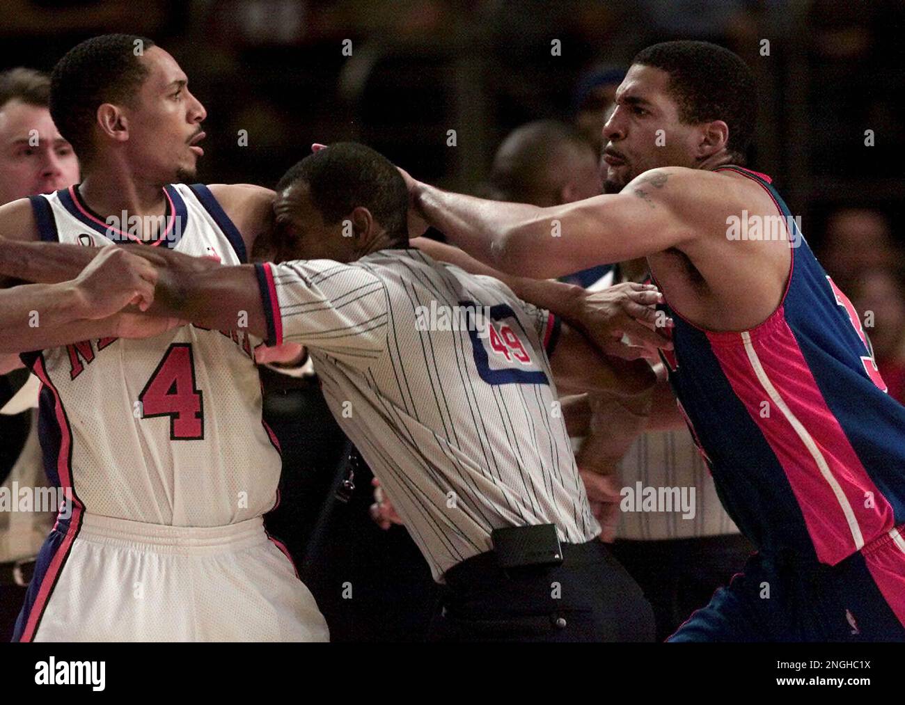 Referee Tom Washington gets between New York Knicks Howard Eisley and ...