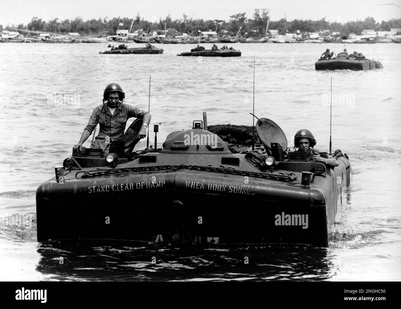 U.S. Marine armored personnel carriers move through the water arriving ...