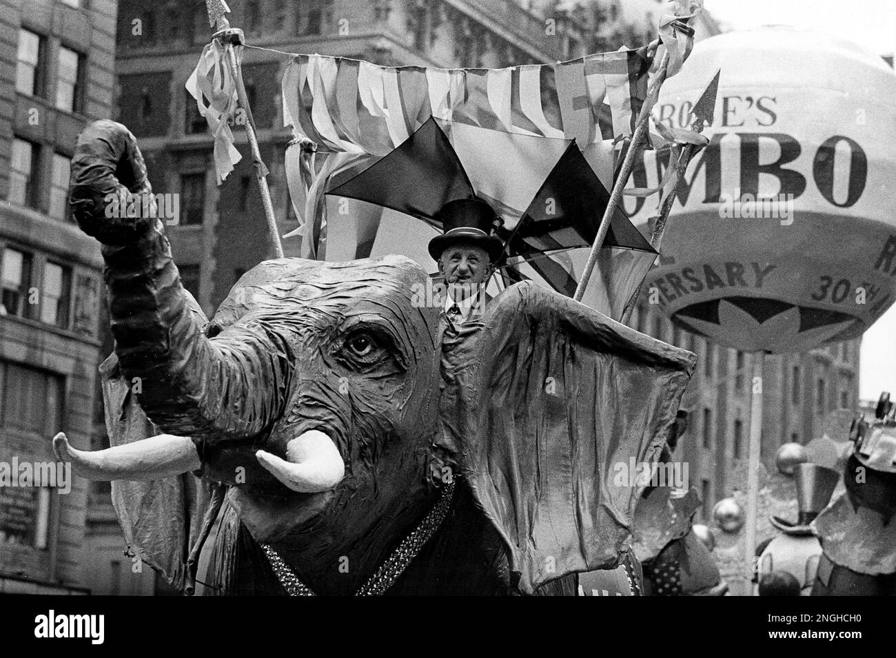 Comedian Jimmy Durante rides on a Jumbo the elephant float during the ...