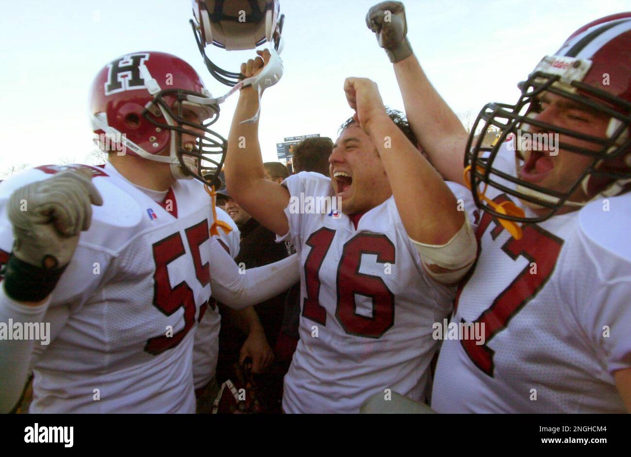 Harvard quarterback Neil Rose, center, celebrates Harvard's victory ...