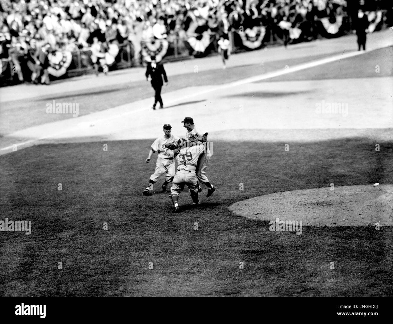 Brooklyn Dodgers pitcher Johnny Podres is lifted by catcher Roy ...