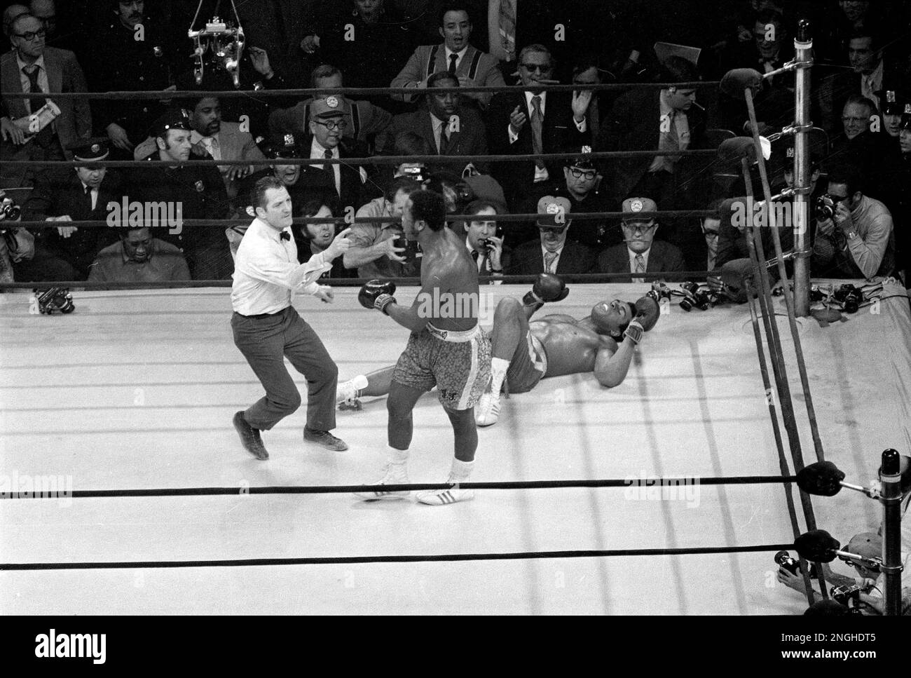 Boxer Muhammad Ali lies on his back after being knocked down in the ...