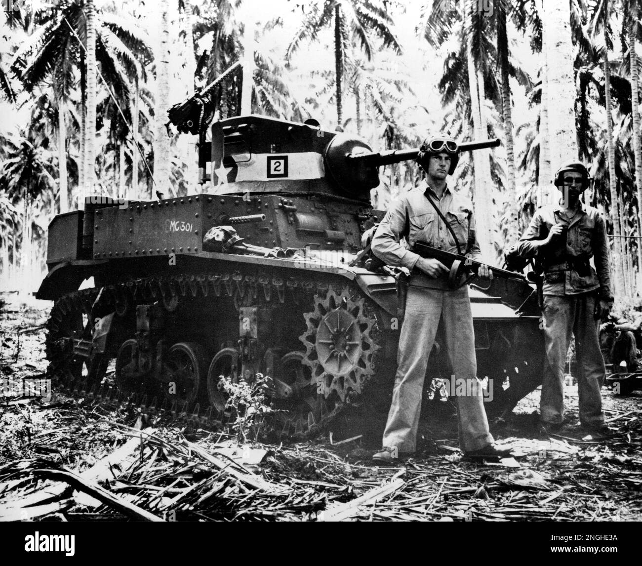 Two alert U.S. Marines stand beside their small tank on Guadalcanal in ...