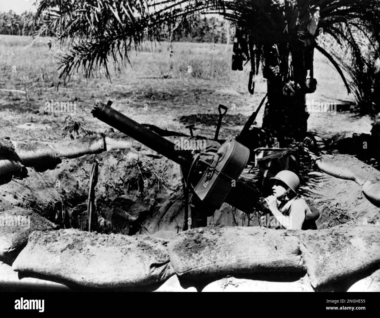 A U.S. Marine Corps gunner stands in an anti-aircraft post behind his ...