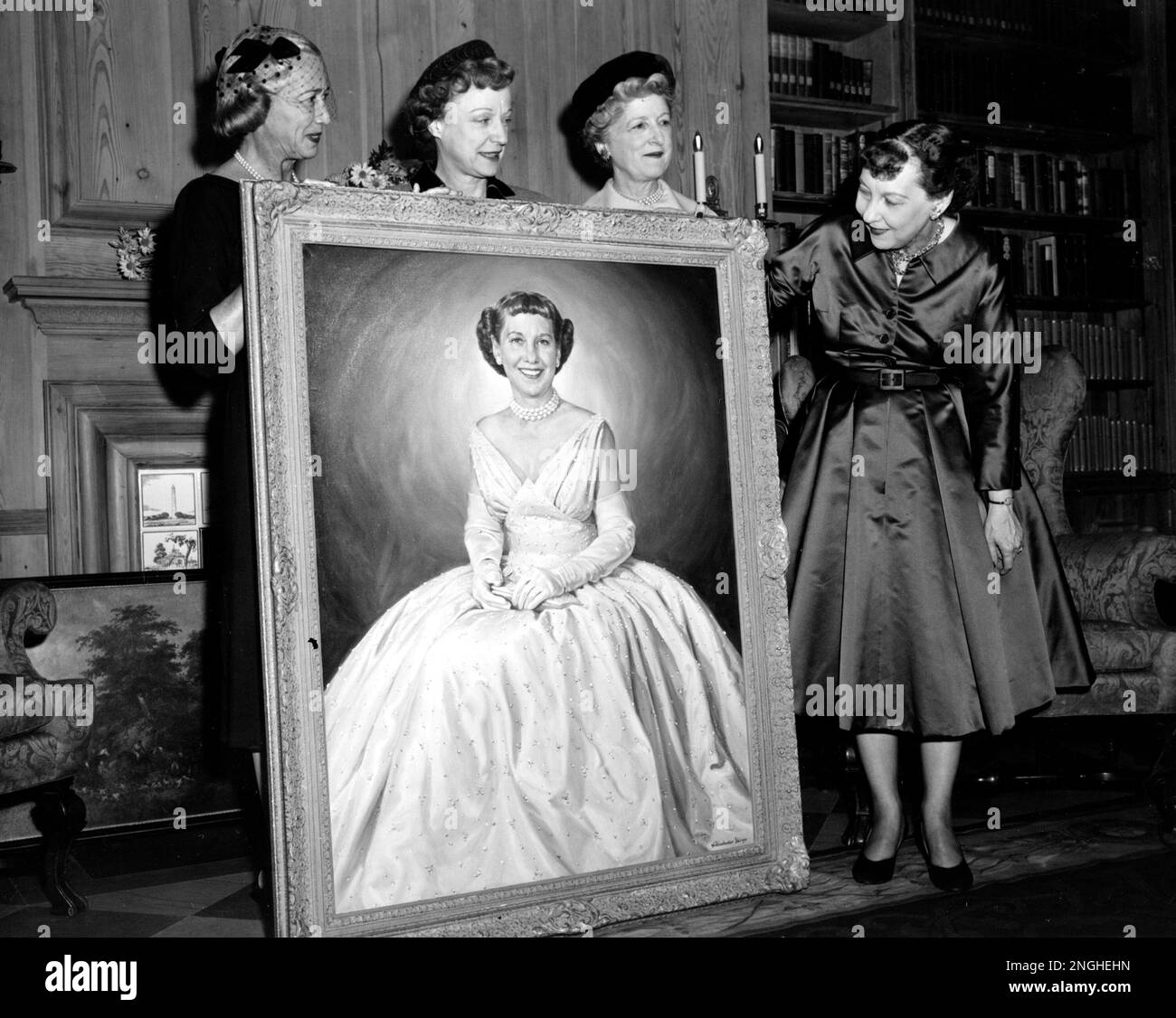 First lady Mamie Eisenhower looks at an oil painting of herself, a gift ...