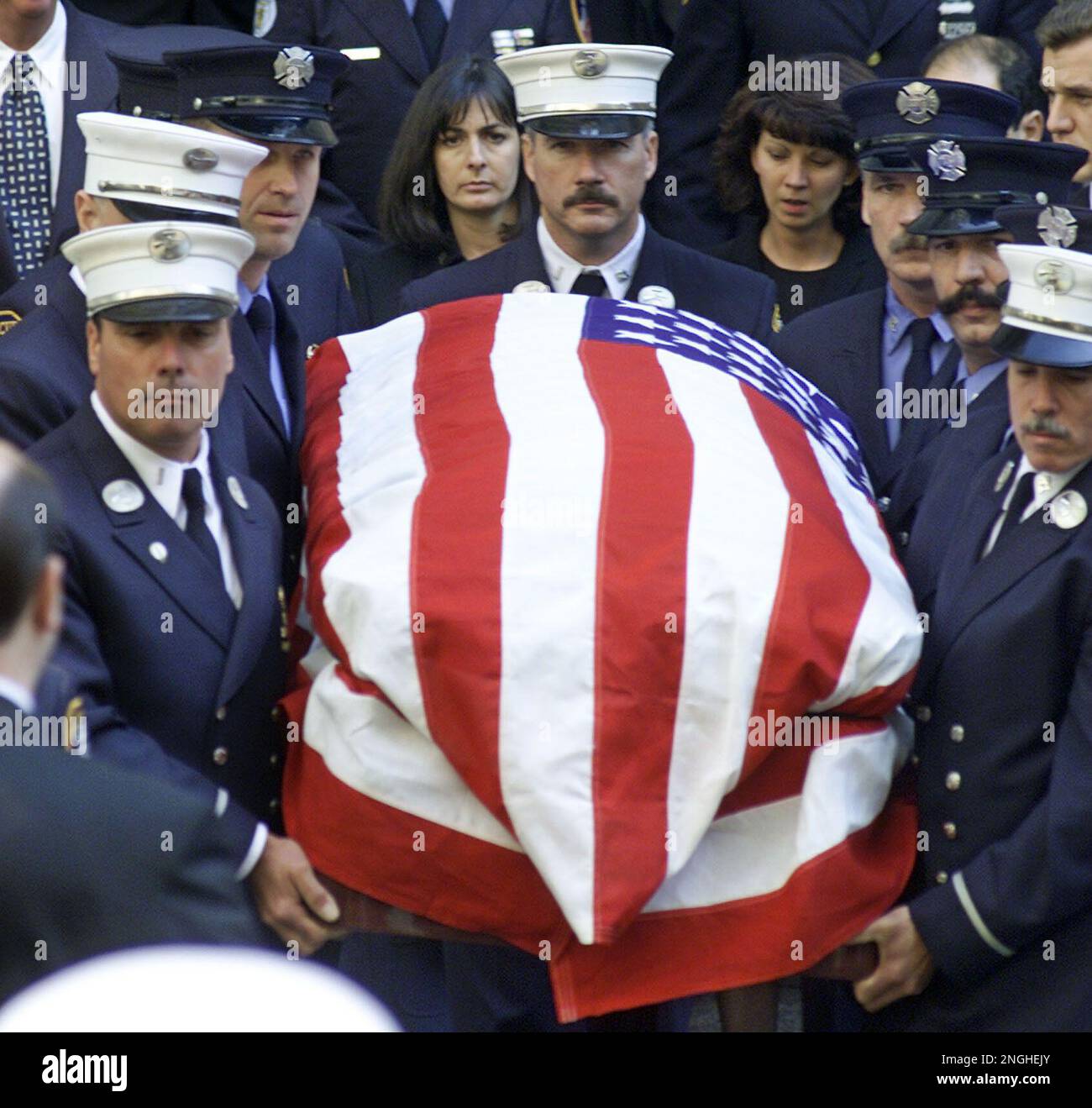 Beth Petrone-Hatton, background left, follows the casket of her husband, New York City Fire Dept ...