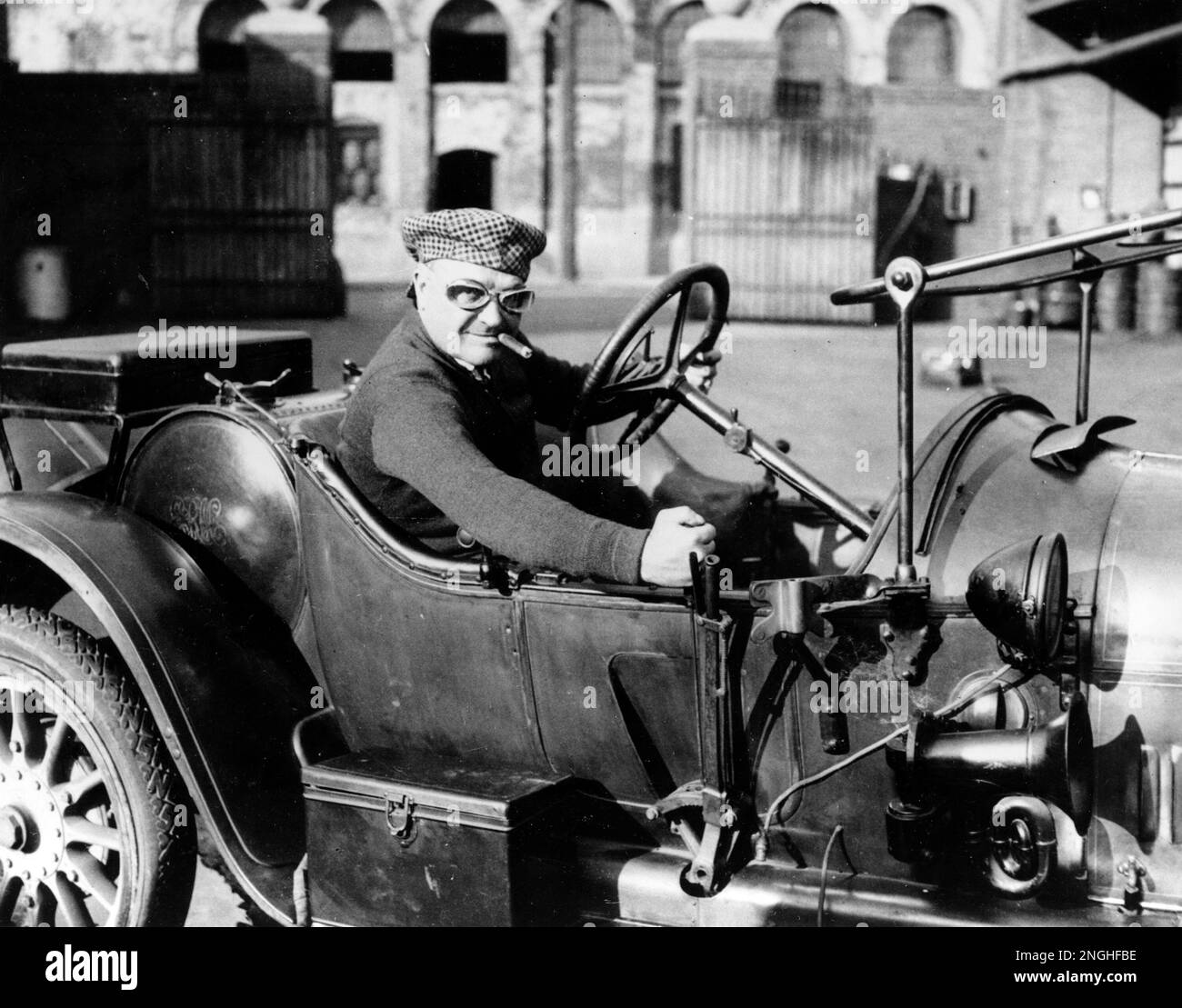 American auto racing pioneer Barney Oldfield tries the gears of his ...