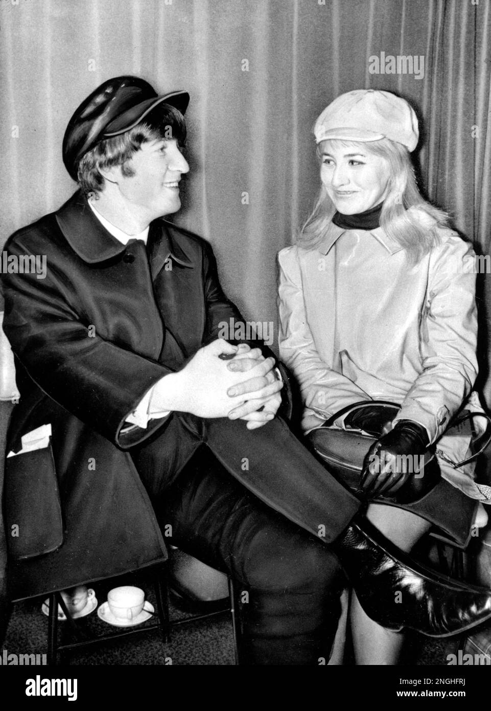 Beatle John Lennon and his wife, Cynthia, sit in London Airport ...
