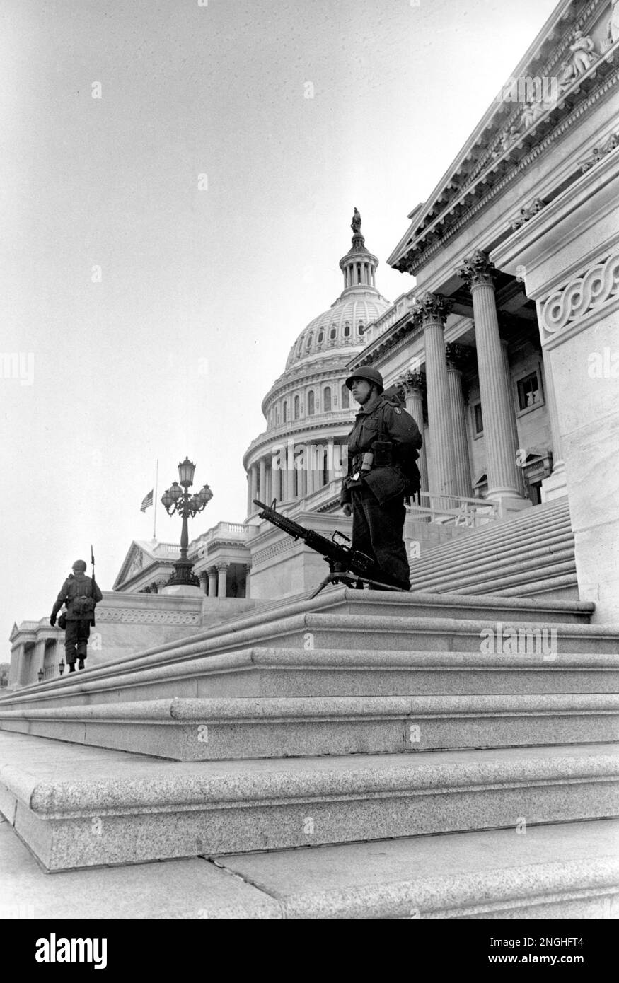 Troops, one with a machine gun, stand guard on the steps of the U.S ...