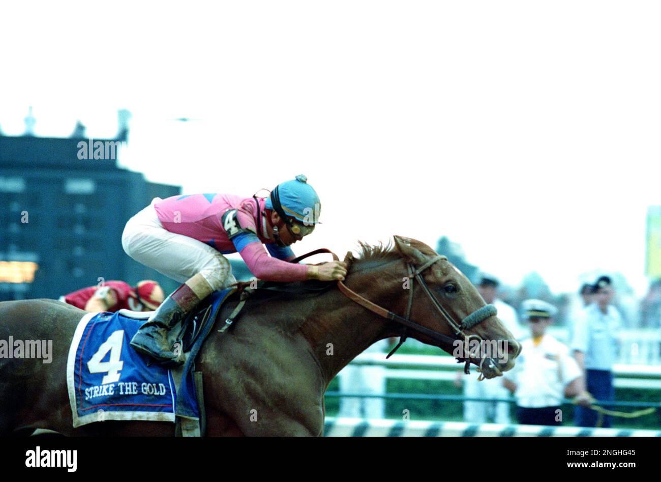Jockey Chris Antley rides Strike the Gold (4) to the finish line to win ...
