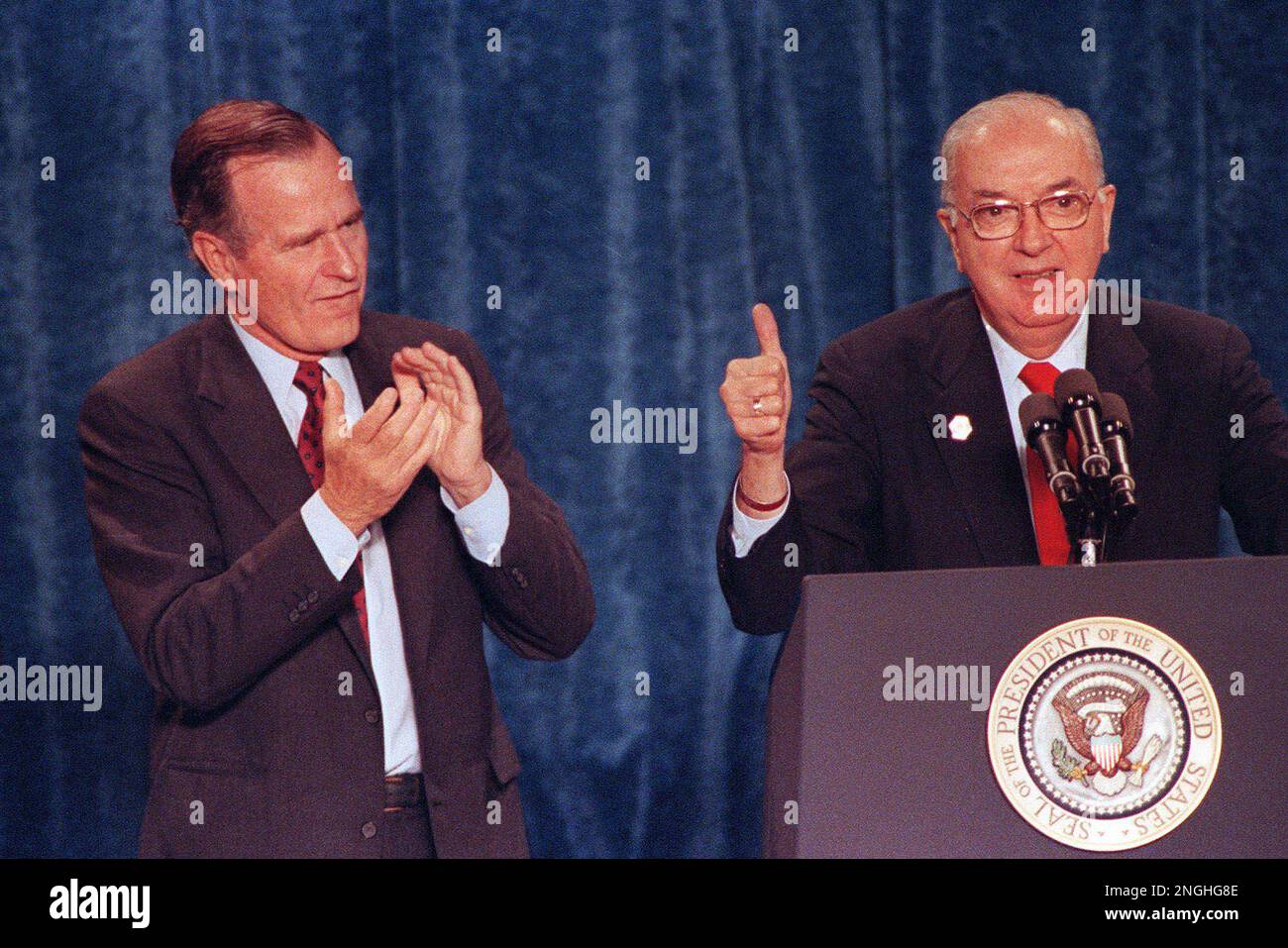 Sen. Jesse Helms, R-N.C., gives the thumbs up sign as President George ...
