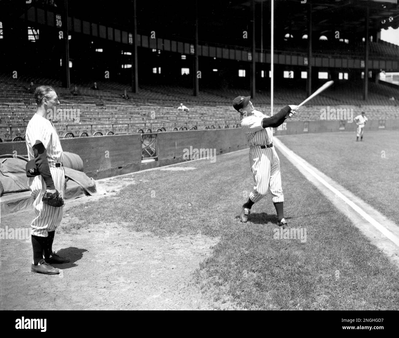 New York Yankees first baseman Lou Gehrig, left, backstops for pitcher ...