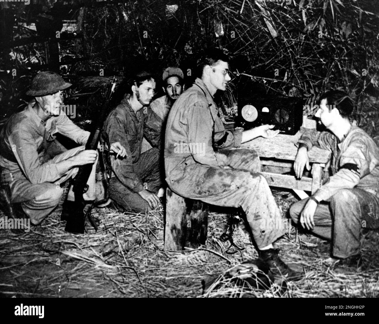 Soldiers with the American forces on Bataan, Philippines, listen to the ...