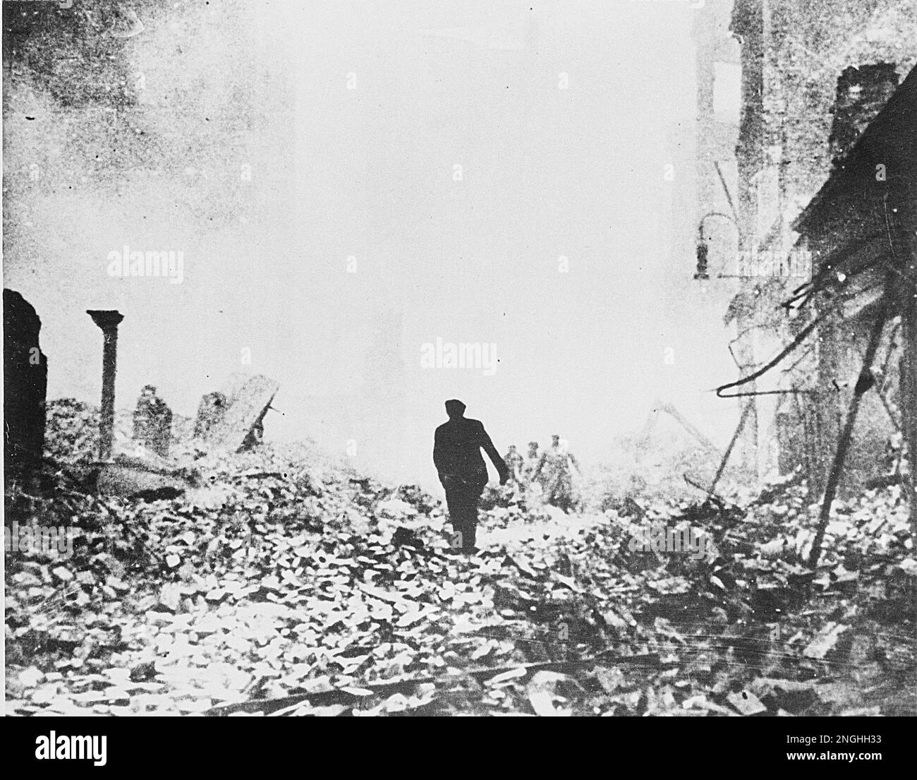 Nazi civilians pick their way through debris and destruction in the ...