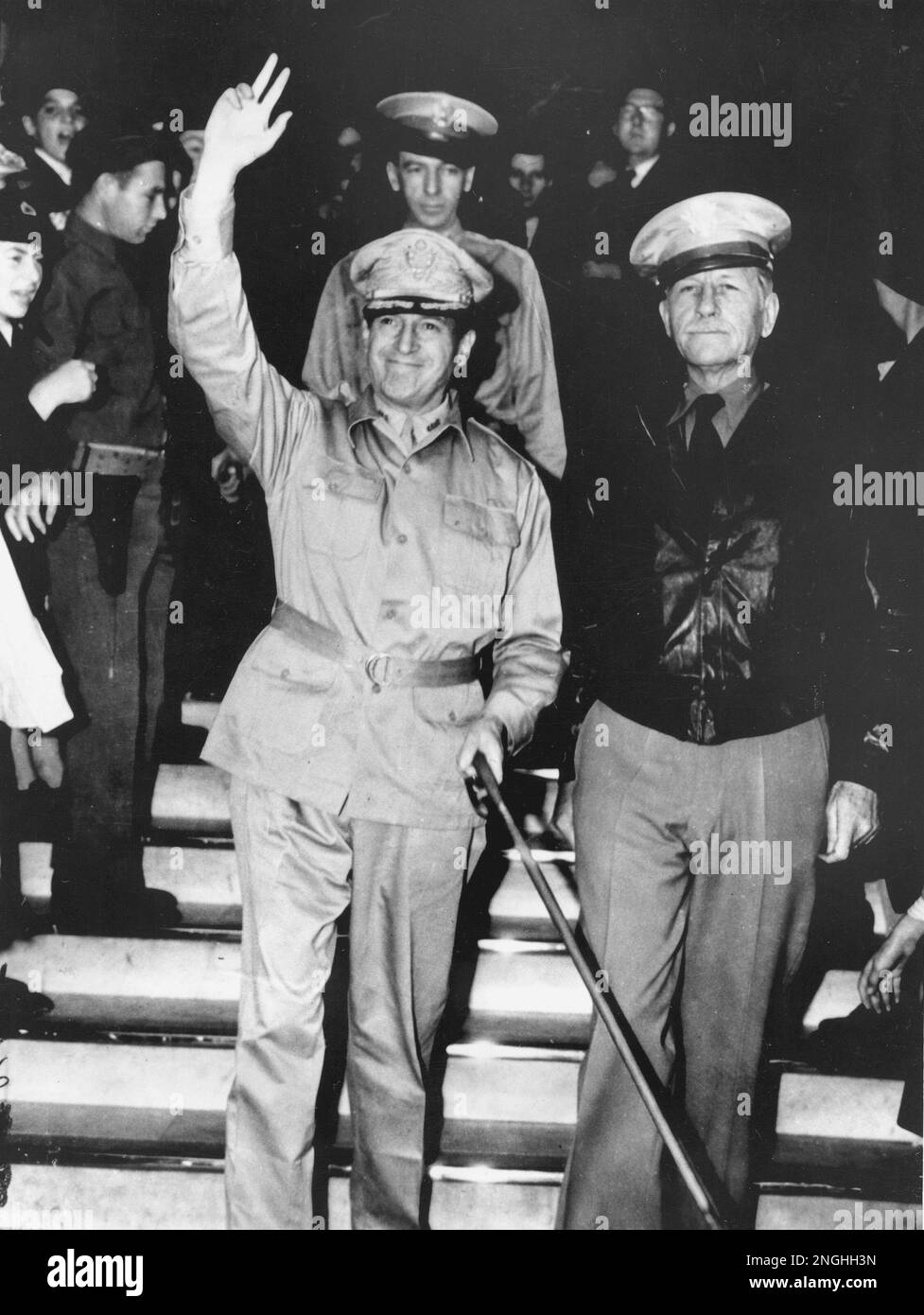 U.S. Gen. Douglas MacArthur smiles and waves as he is greeted on his ...