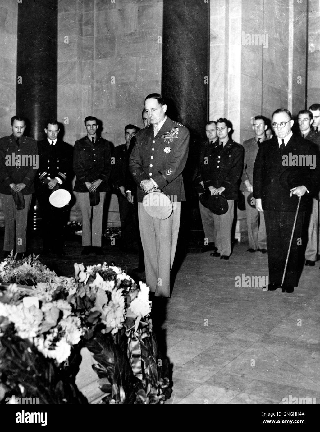 U.S. Gen. Douglas MacArthur stands with his head bowed at a shrine in ...