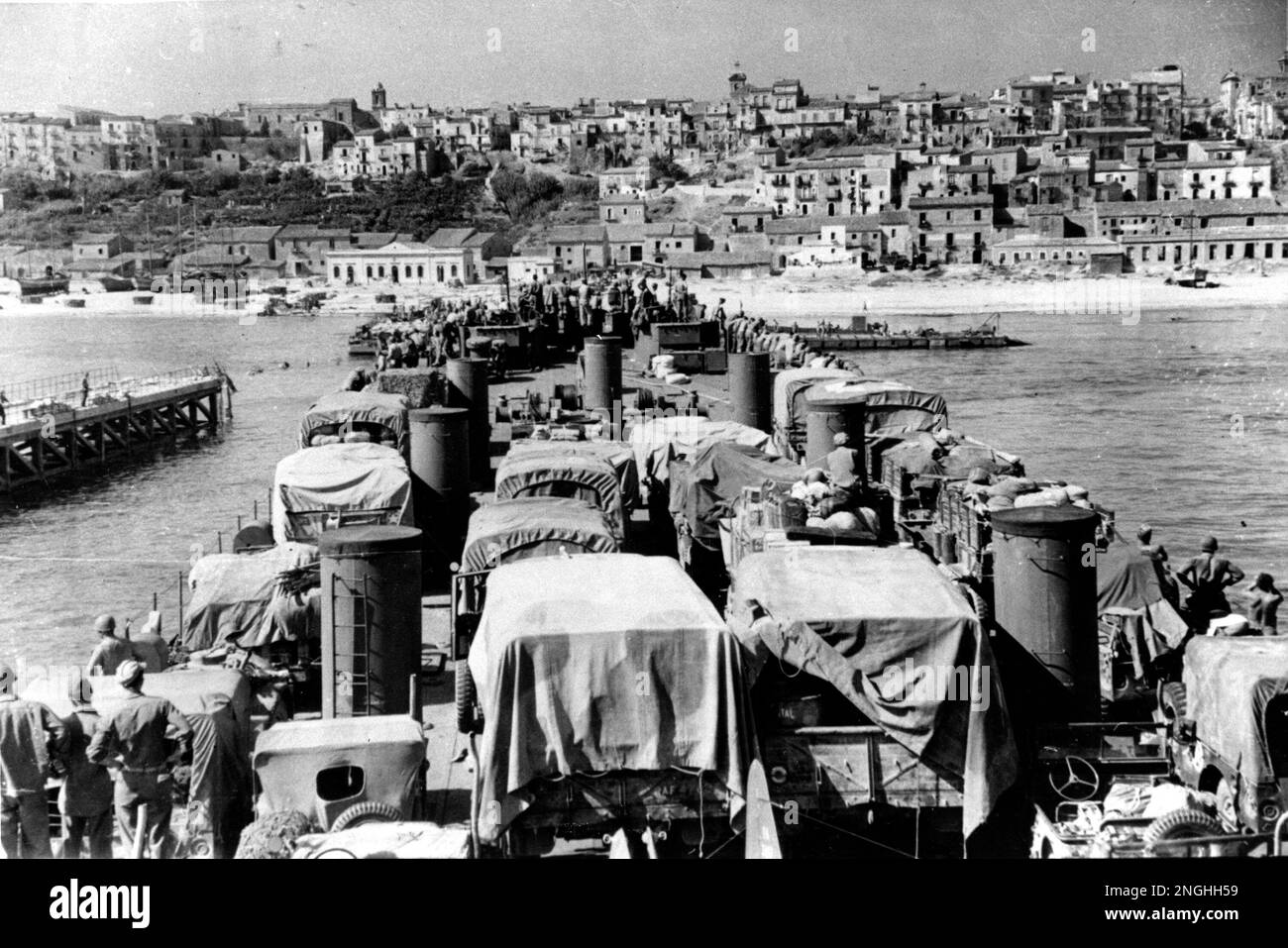 A landing craft carrying American forces, trucks and supplies ...