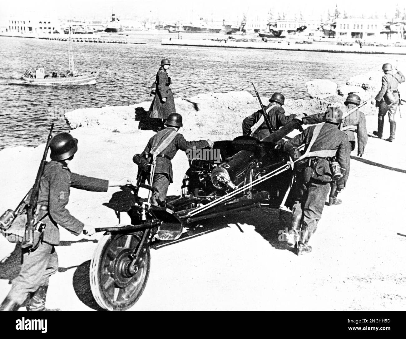 German soldiers pull a field gun along the harbor front at Marseille ...