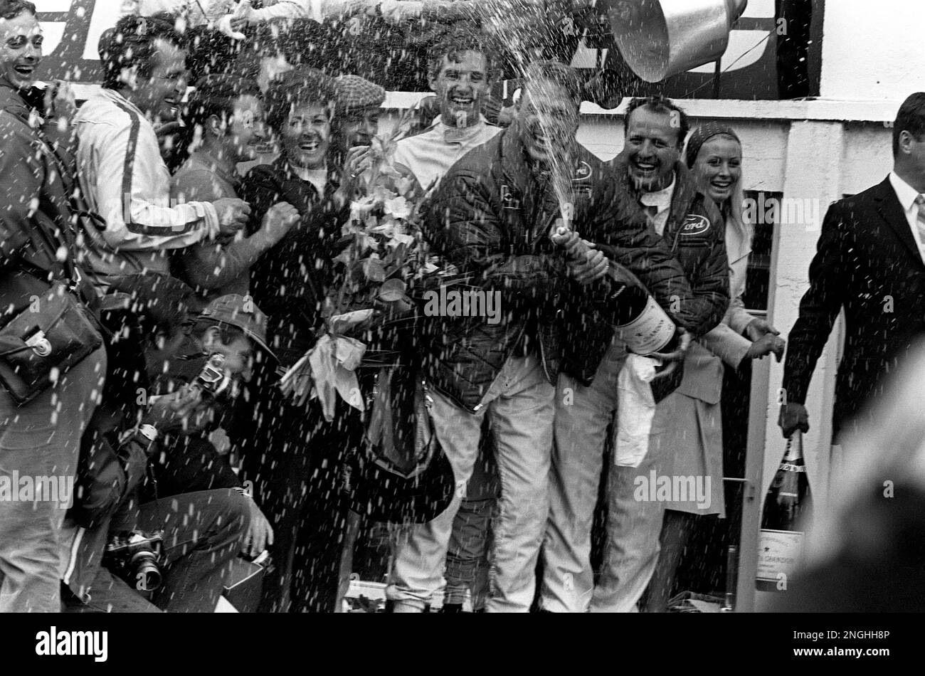 American co-drivers Dan Gurney, left and A.J. Foyt spray the victors ...